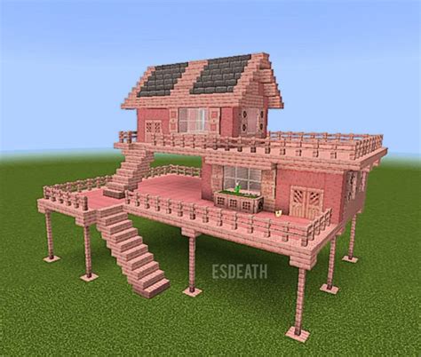 A Large Pink House Sitting On Top Of A Lush Green Field