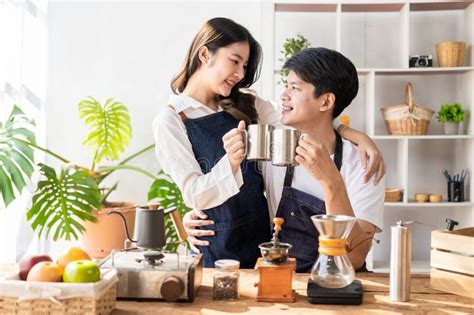 Asian Man And Woman Preparing Food And Bread To Make A Healthy Breakfast Enjoying Cooking With