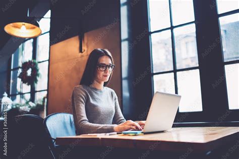 Babe Charming Female IT Programmer Loading Upgraded Software Into Laptop Computer To Improve