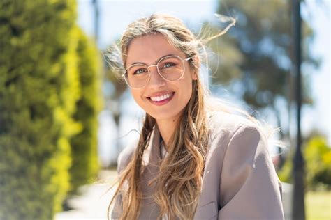 Premium Photo Pretty Blonde Uruguayan Woman With Glasses At Outdoors
