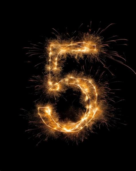 Premium AI Image A Close Up Of A Number Made Of Sparklers On A Black
