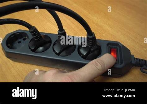 Insert Plug Into Extension Cord Socket By Pressing Red Push Button Switch With Your Finger