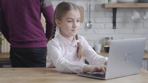 Close Up Of Beautiful Caucasian Teenage Girl Typing On Laptop Keyboard While Unrecognisable Man