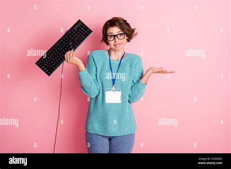 Photo Of Clueless Young Lady Hold Keyboard Programmer Wear Id Badge
