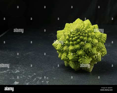 Romanesco Broccoli Head On A Dark Stone Surface Cabbage Close Up Fibonacci Sequence For