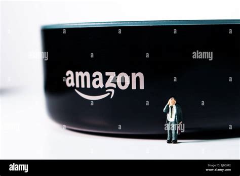Miniature Businessmen Standing In Front Of Amazon Echo Dot Amazon Echo Also Known As Alexa Is