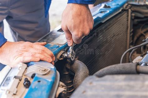 A Man Replaces An Old Broken Radiator In A Car With A New One Stock Photo Image Of Industry