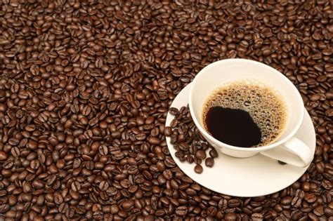 Premium Photo Cup Of Coffee On Brown Coffee Beans