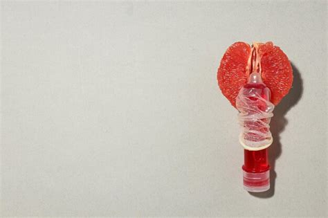 Premium Photo Condom On A Bottle Of Lubricant Next To A Juicy Cut
