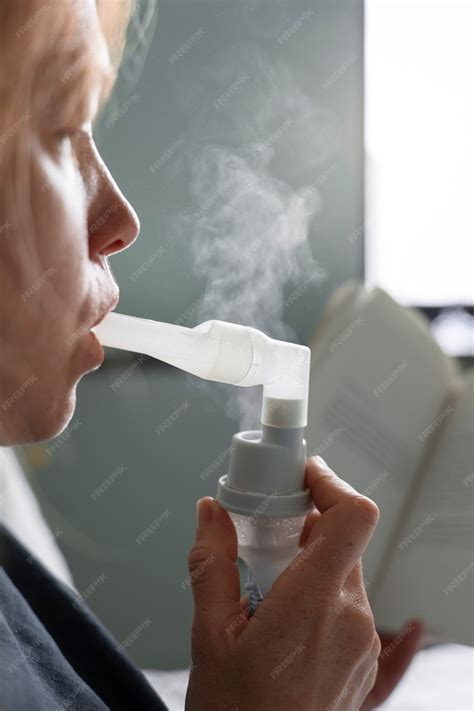 Free Photo Side View Woman Using Nebulizer At Home