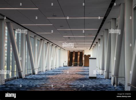 A Bright Modern Hallway Features Floor To Ceiling Windows And Angled