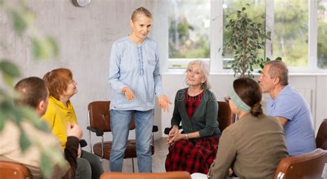 Senior Female Tutor Leading Educational Class For Elderly Stock Image
