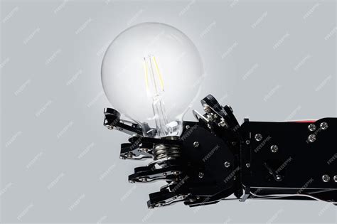 premium photo real robot s hand holding lightbulb on grey background