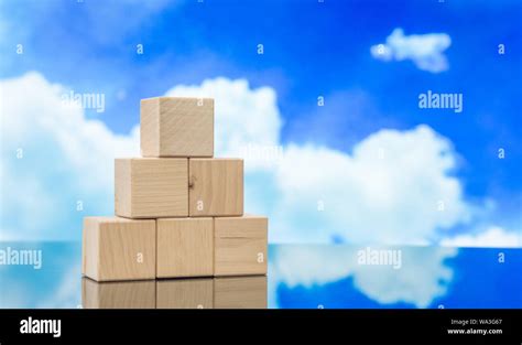 Pyramid Of Wooden Cubes Against The Blue Sky Wooden Cube Stacked In Pyramid Shape Without