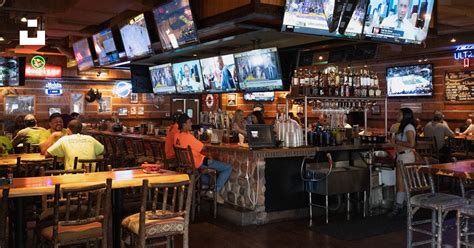 바에 앉아 Tv를 보고 있는 한 무리의 사람들 사진 Unsplash의 무료 플로리다 이미지