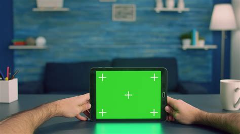 Point of view of business man hands holding tablet computer with mock up green screen chroma key ...