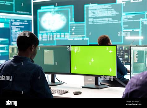 Governmental Hackers Working On Computer With Green Screen To Protect
