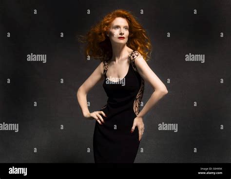 Redhead Model In Black Dress In Studio Stock Photo Alamy