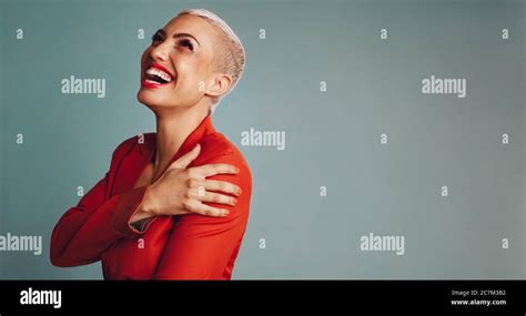 Fashionable Woman With Blonde Pixie Hairstyle Looking Away And Laughing