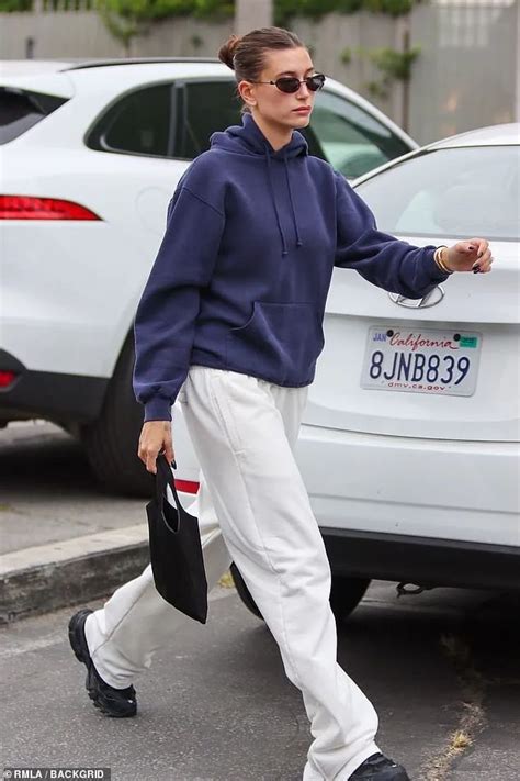 Hailey Bieber Dons A Navy Hoodie And Black Sunglasses As She Steps Out