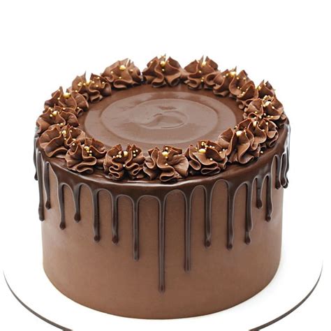 a chocolate cake with chocolate icing and flowers on the top is ready ...
