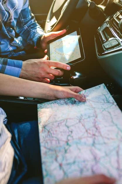 Premium Photo Couple Comparing Paper Map And A Gps Navigator