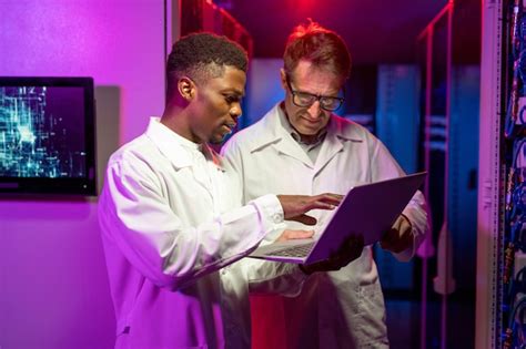 Premium Photo Multi Ethnic It Engineers Analyzing Data On Laptop