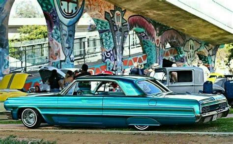 Vintage Blue Car Parked In Front Of Colorful Wall Turquoise Lowrider