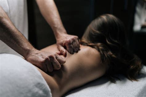 Close Up Hands Of Masseur Male Performing Deep Tissue Technique On