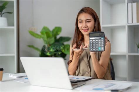Accounting And Data Analysis A Woman Using A Calculator In A Virtual Meeting Showcasing Her