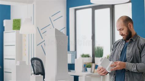 Close Up Of Man Architect Analyzing Blueprints Plans On Table To Design