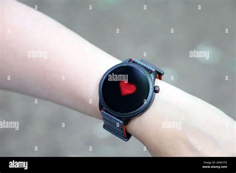 Smart Watch On Female Hand Measuring Heart Rate Round Display With App For Health Monitoring