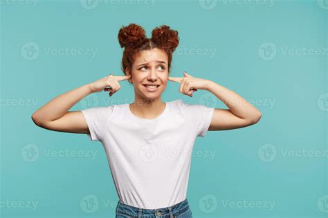 Discontented Young Lovely Brown Haired Curly Woman With Natural Makeup