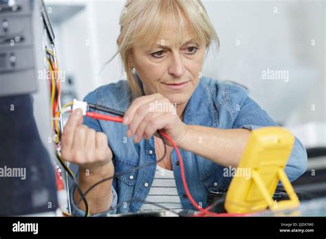Senior Female Technician Using Voltage Meter Stock Photo Alamy