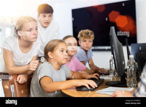 Computer Lesson In Classroom Classmates Solve Problems On Computer