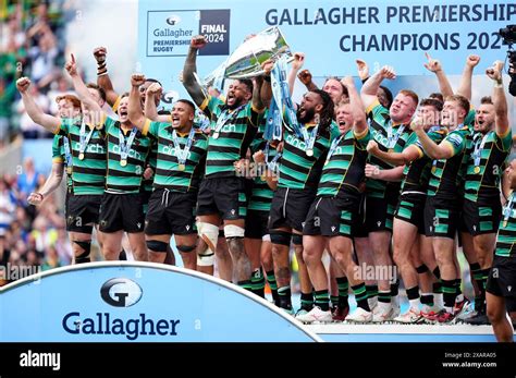 Northampton Saints Players Celebrate On The Pitch With The Trophy After Winning The Gallagher