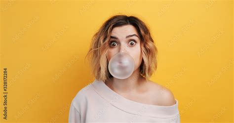 Portrait Babe Sexy Girl Diligently Inflates Bubble Of Chewing Gum And Rounds Her Eyes From The