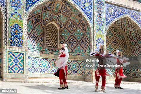 Uzbek Female Folk Dancers In Red National Clothes Travelling And