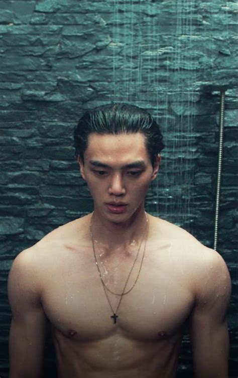 A Shirtless Young Man Standing In Front Of A Shower With Water Coming