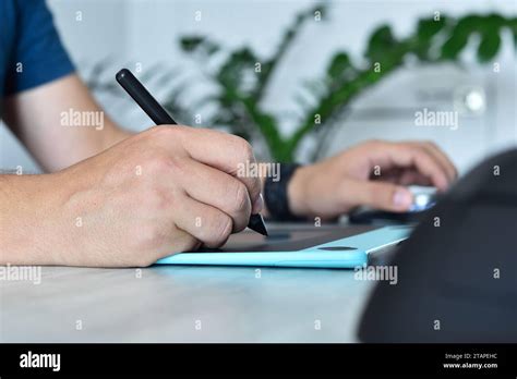 Designer Drawing On Graphic Digital Tablet And Navigation Control Wheel Keyboard Creative