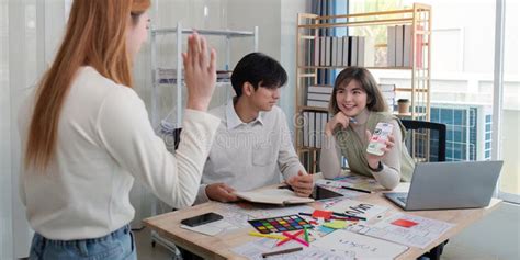 Creative Ux Ui Team Collaborating On Design Project In A Modern Office Showcasing Diverse