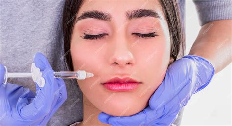 Premium Photo Young Woman Gets Injection Of Botox In Her Lips Woman In Beauty Salon Plastic