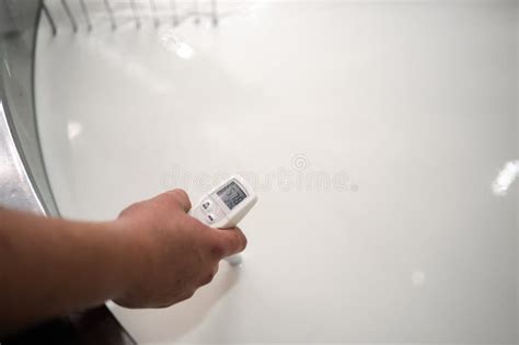 Cheesemaker Measuring Temperature And Acidity With Ph Meter In A Large