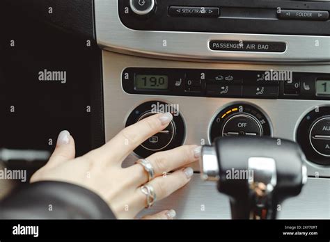 Woman Turning Button Of Air Conditioning Regulating Temperature In Car Stock Photo Alamy