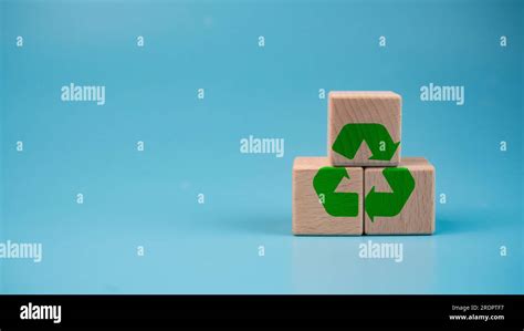Stacked Wooden Blocks With Green Recycle Symbol Recycling Concept