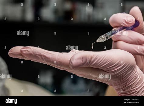 Contour Plastic A Cosmetologist Injects A Botulinum Toxin To Tighten