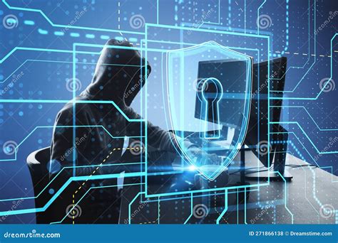 side view of hacker using computers at desktop with glowing safety and