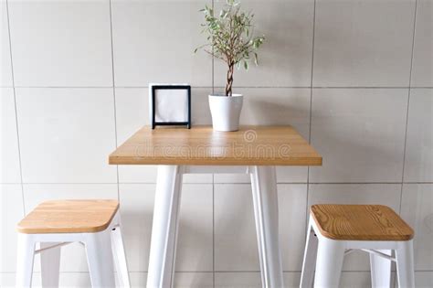 Minimalist High Table With Two Stools Small Plant Photo Frame Modern