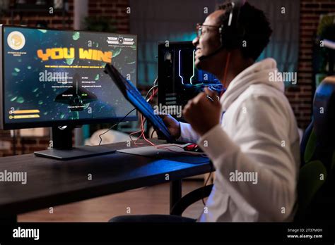 Gamer Playing Intense Classic Arcade Spaceship Racing Videogame