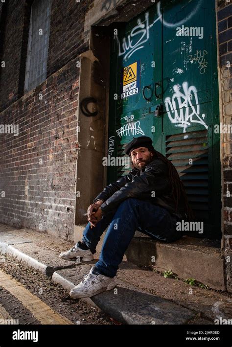 Street Life A Homeless Character Smoking A Cigarette In A London Back